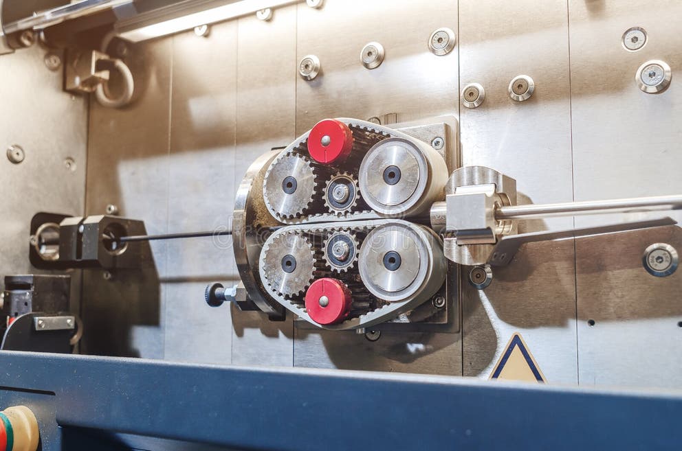 Pulling the Wire through the Gears on the Machine. Part of Industrial ...