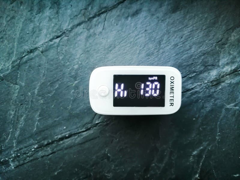 A Pulse Oximeter on Blue Background Stock Image - Image of light ...