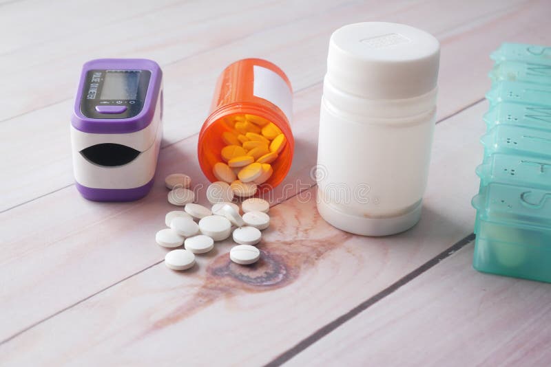 Pulse Oximeter, Medical Pills and Container on Table Stock Photo ...