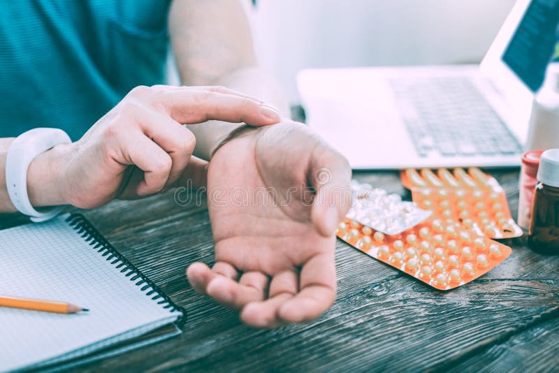 Responsible Sick Man Measuring the Pulse in a Room Stock Photo - Image ...