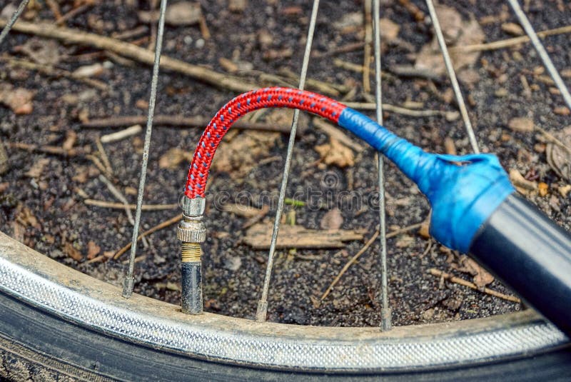 Pumping a Bicycle Wheel with an Old Pump Stock Image - Image of bicycle ...