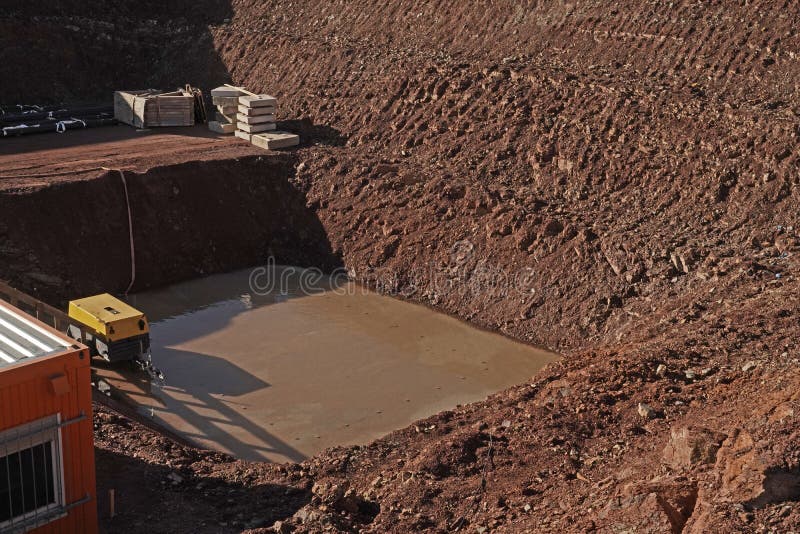Pumping Out Water in the Excavation Pit Stock Photo - Image of pumping ...