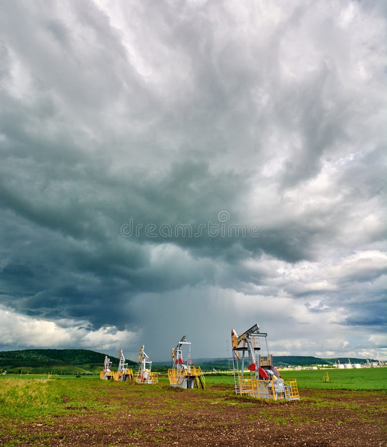 Pumping Unit for Pumping Oil on a Background of Cumulus Clouds and ...