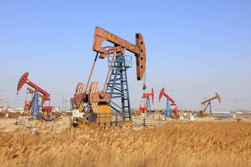 Pumping Unit and Reed Under Blue Sky Stock Photo - Image of operations ...