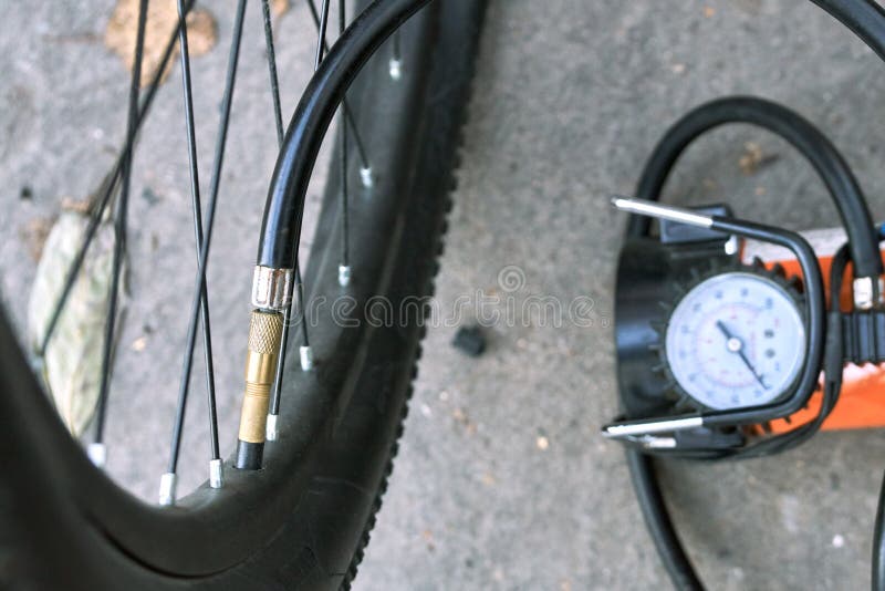 Pumping Up a Bicycle Tire Using an Electric Air Car Compressor Stock ...