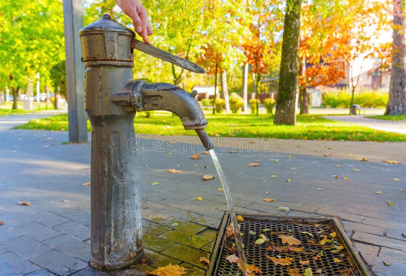 Pumping Water from the Park Hand Pump Well Stock Photo - Image of ...