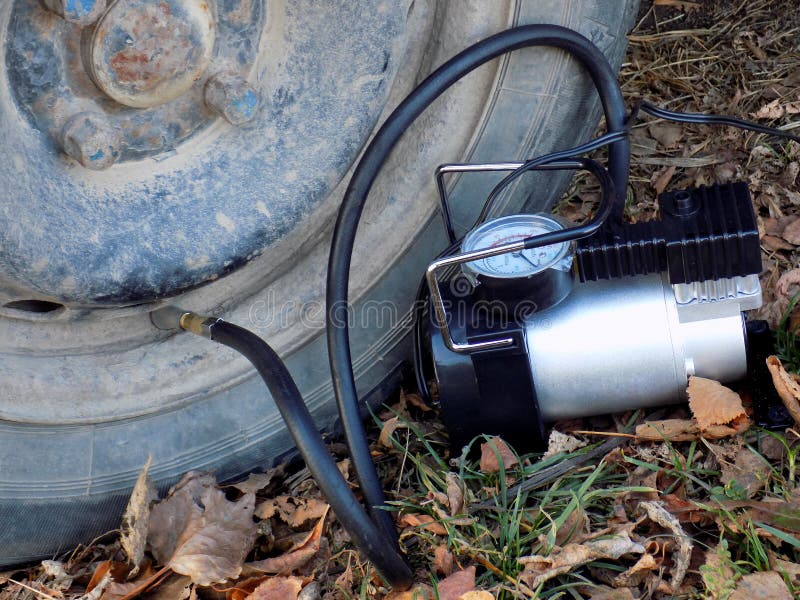 Pumping a Wheel in a Road with a Compressor Stock Photo - Image of ...