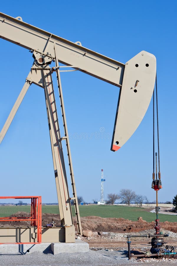 Oil Drilling Rig in a Hay Field Stock Photo - Image of drilling, field ...