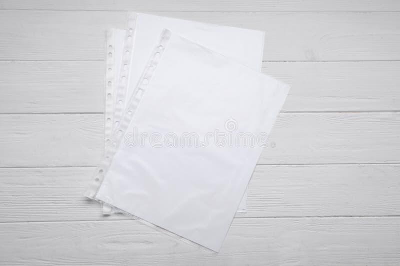 Punched Pockets with Paper Sheets on White Wooden Table, Flat Lay ...