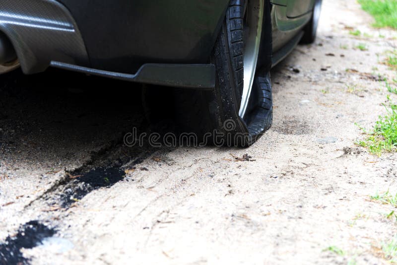 Punctured Wheel of a Modern Car on the Road. Car Tire Puncture Stock ...