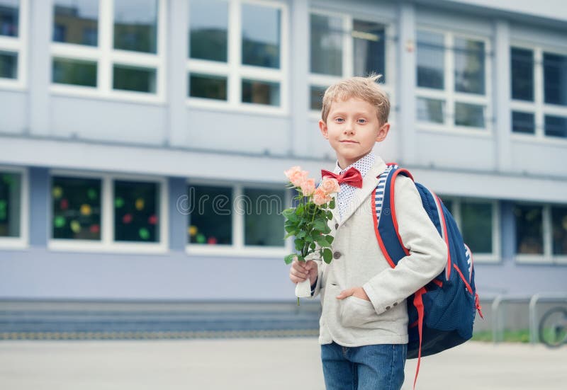 Pupil boy near the school stock image. Image of backpack - 59140707