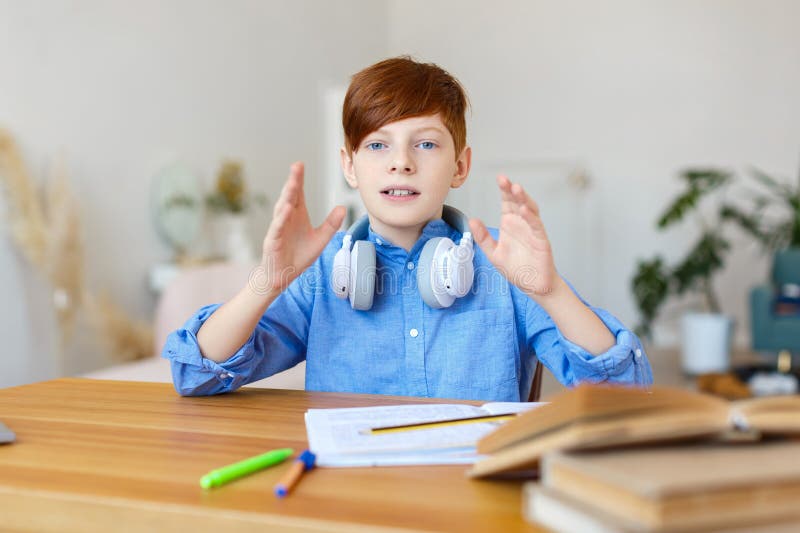 Pupil Boy Sits in Front of the Camera and Gives a Presentation on His ...