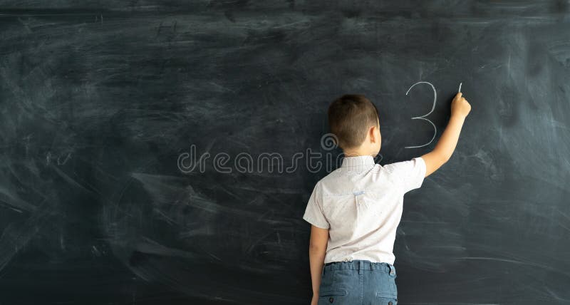 Pupil in Class at a Math Lesson Writes on a Chalk Board with Chalk ...