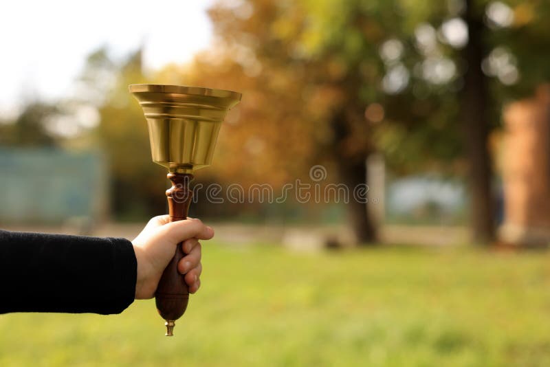 Pupil Holding School Bell Outdoors on Sunny Day, Closeup. Space for ...