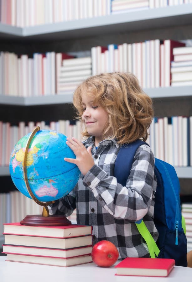 Pupil Looking at Globe in Library at the Elementary School. Nerd School ...