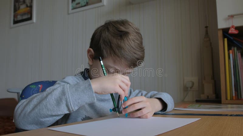 Schoolboy Make Homework and Using Drawing Compass and Ruler To Draw a ...
