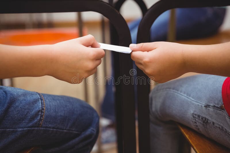 Pupil Passing a Note To a Classmate Stock Image - Image of class, back ...