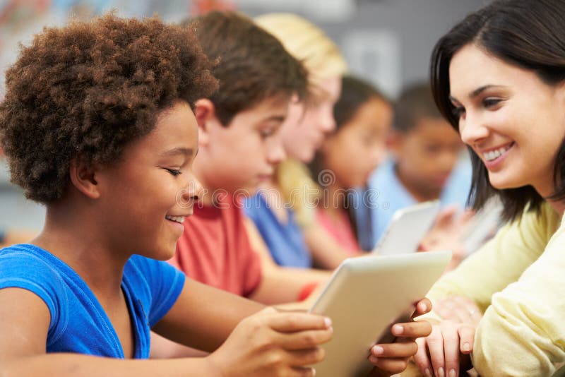 Pupils in Class Using Digital Tablet with Teacher Stock Photo - Image ...
