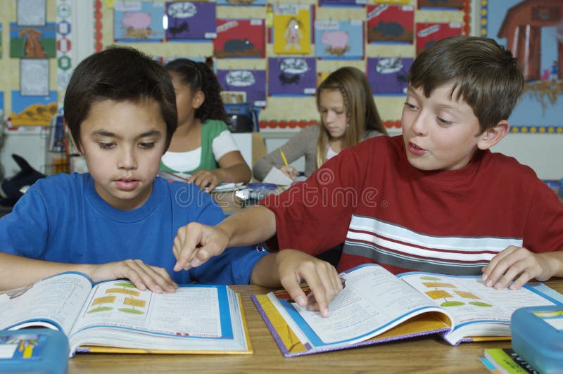 Pupils in Classroom Reading Textbooks Stock Image - Image of four ...