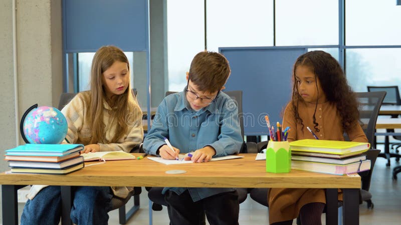 Pupils of Elementary Class Doing Homework. Kids Learning To Read and ...
