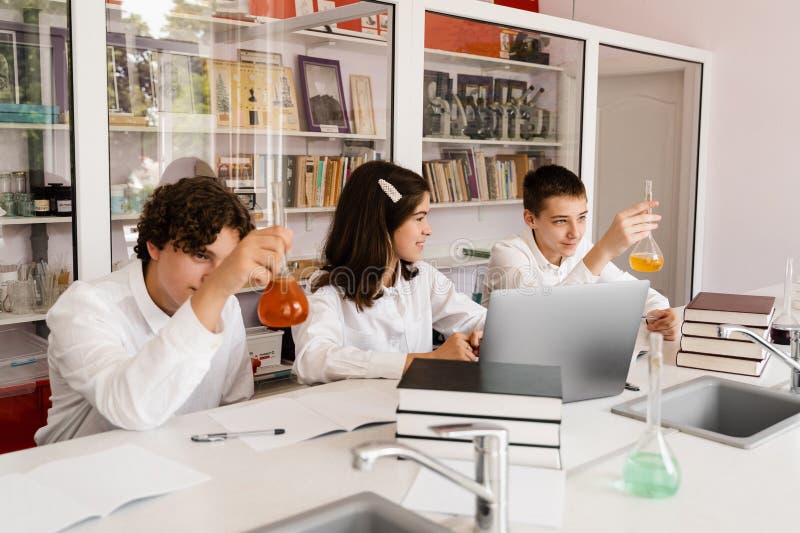 Pupils Holding Flasks with Liquid for Experiments in Laboratory ...