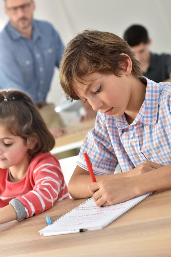 Pupils at School Learning and Writing Stock Photo - Image of hair ...