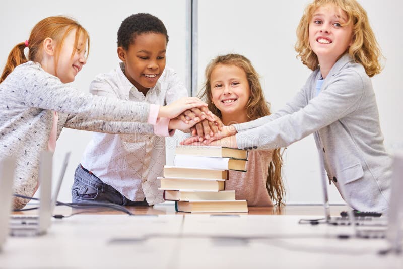 Pupils Stack Hands Together in the Classroom for Motivation Stock Photo ...