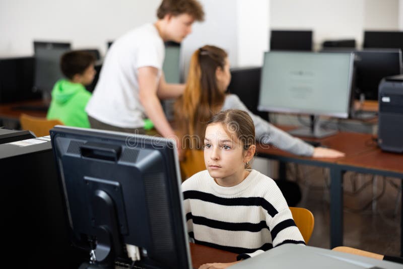 Pupils Using Computers at Lesson, Teacher Teaching Them in Class Room ... Pupils Using Computers at Lesson, Teacher Teaching Them in Class Room ...