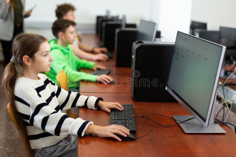 Pupils Using Computers at Lesson, Teacher Teaching Them in Class Room ... Pupils Using Computers at Lesson, Teacher Teaching Them in Class Room ...