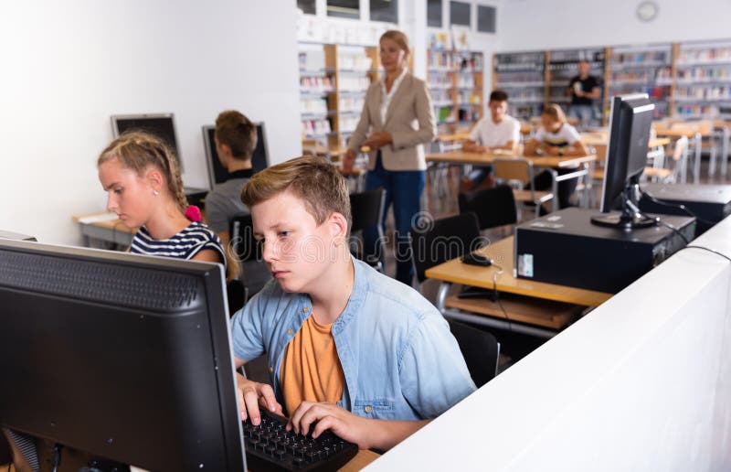 Pupils Using Computers at Lesson, Teacher Teaching Them Stock Photo ... Pupils Using Computers at Lesson, Teacher Teaching Them Stock Photo ...