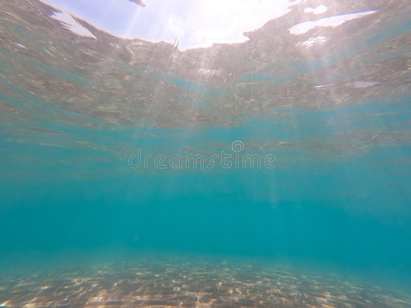 Pure Water. Under the Water, the Rays of the Sun and the Sandy Bottom ...