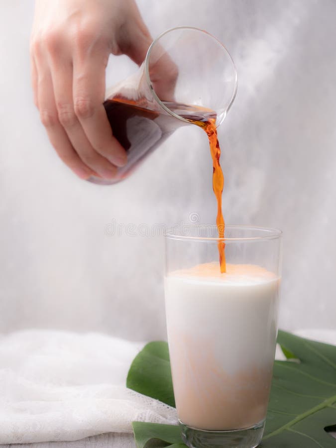 Puring tea in milk glass stock photo. Image of beverage - 145881636