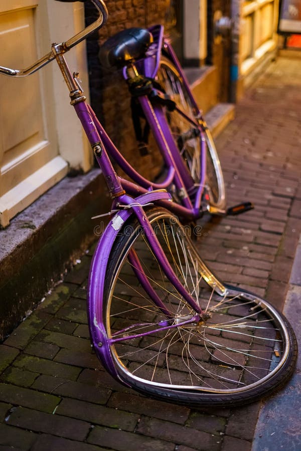 Purple Bicycle with a Broken Wheel in Amsterdam Street Stock Photo ...