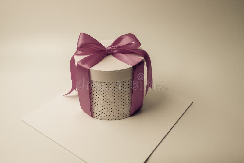 A Purple Bow and Ribbon is Wrapped into a Small Gift Box Stock Photo ...