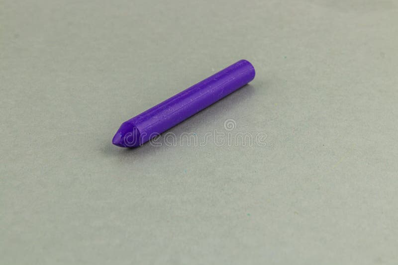 Purple Crayon Rests on a Plain Surface in Bright Lighting Stock Photo ...