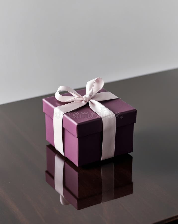Purple Gift Box with Satin Ribbon on a Wooden Surface. Stock Photo ...