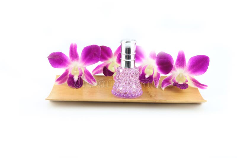 Purple Orchid and Perfume Bottles in Bamboo Dish Stock Image - Image of ...