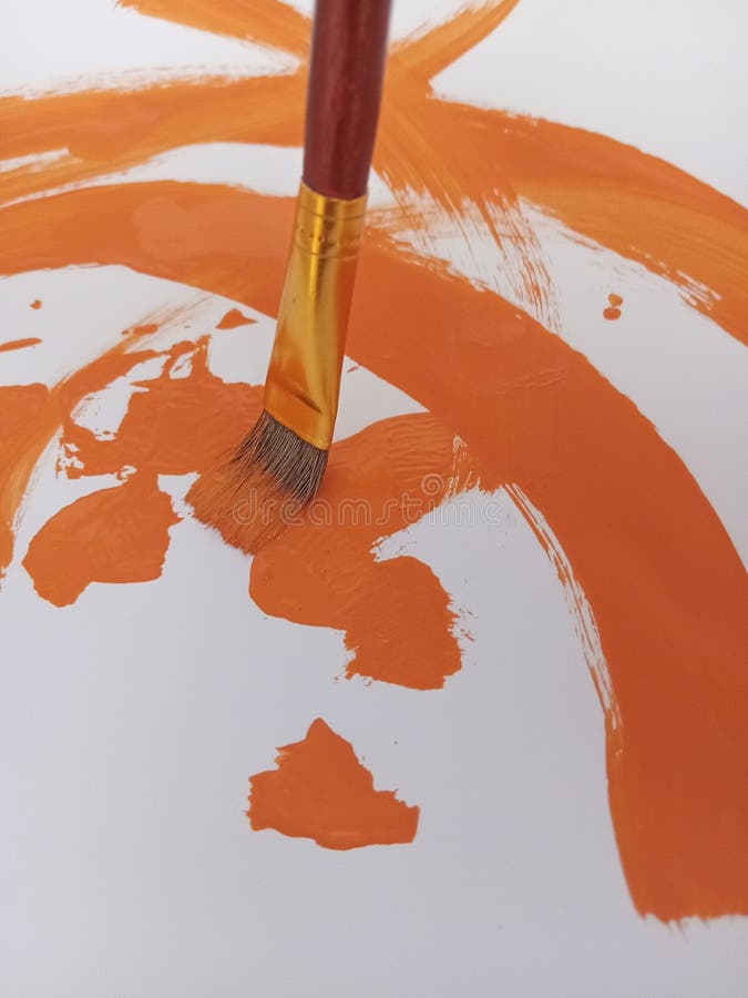 Orange Paint Brush Strokes on a White Background with a Paint Brush ...