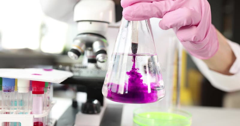 Purple Solution Swirls in Flask with Water at Laboratory Testing Stock ...