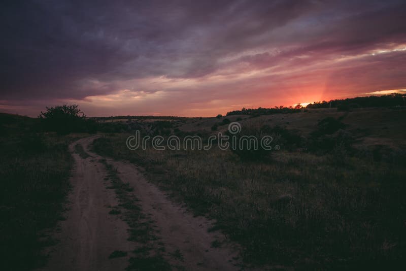 Purple Sunset Against Road with Field and Meadow Stock Image - Image of ...