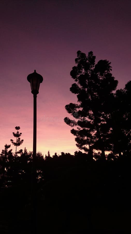 A Purple Sunset with Lamp Post Silhoutte Stock Image - Image of post ...