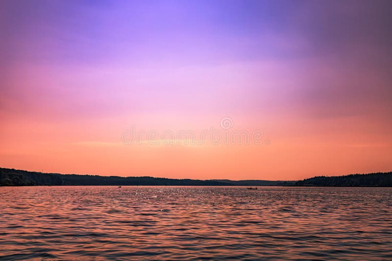 Purple Sunset Over the Lake with Reflection on the Water Ripples Stock ...