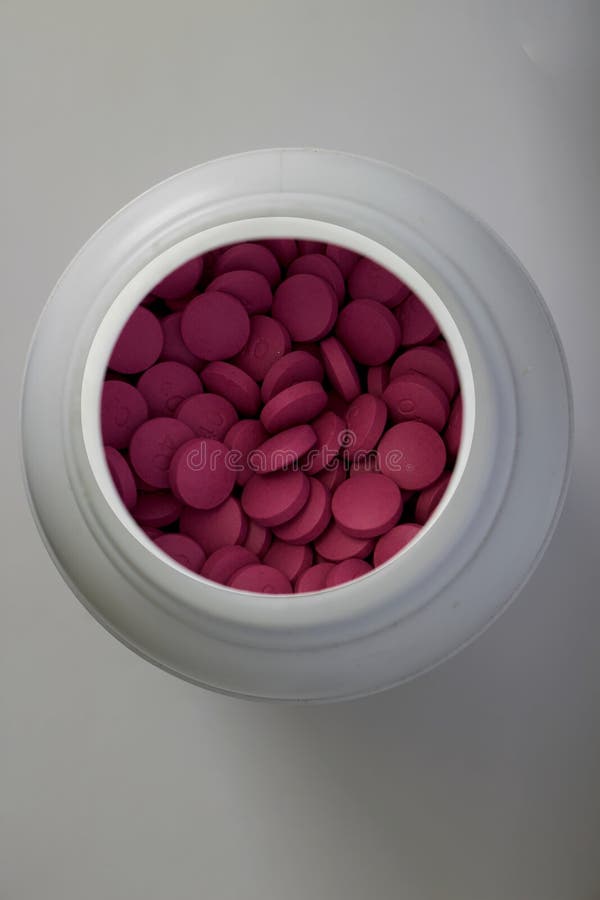 Purple Tablets in White Plastic Jar in Drugstore Concept Stock Image ...