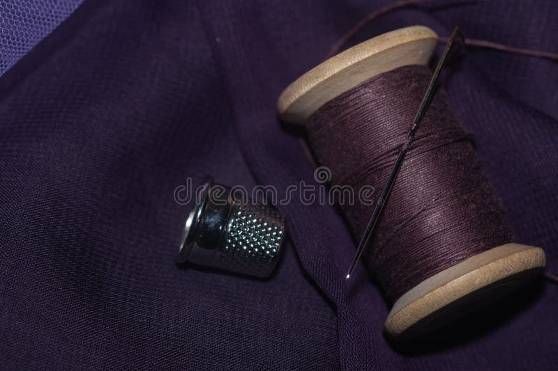 Purple Threads on a Vintage Wooden Spool, Needle and Thimble Stock ...