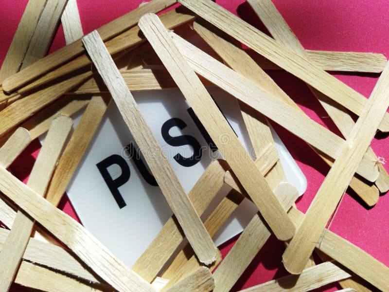 Push Sign Object Decorated with Several Wooden Sticks on a Red ...