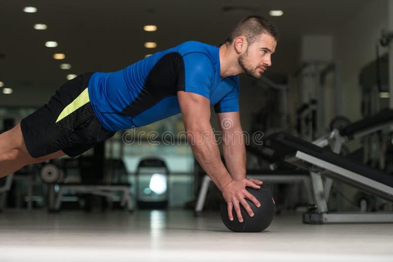 Pushups with Medicine Ball stock image. Image of coach - 77418505