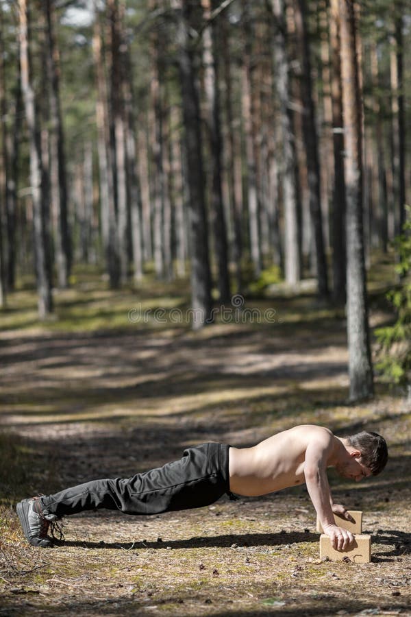 Push-ups in Nature. a Man Plays Sports in the Woods. Stock Photo ...