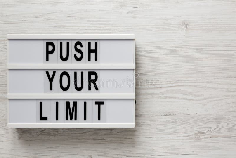 `Push Your Limit` Words on a Lightbox on a White Wooden Surface, Top ...