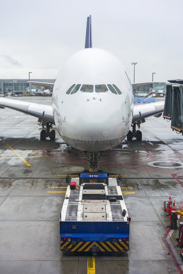 Pushback Tug and a Large Airplane at an Airport Stock Image - Image of ...