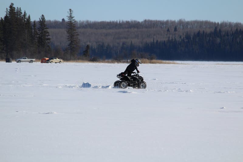 Pushing a Quad Out of a Rut in the Middle of a Frozen Lake Stock Photo ...